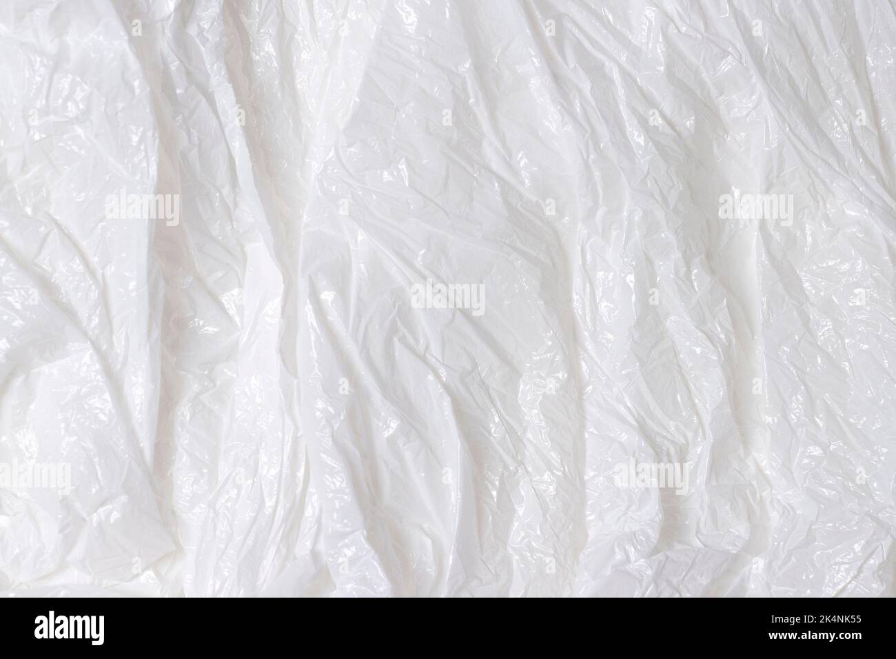 White plastic wrap background. Crumpled wrinkled plastic cellophane ...