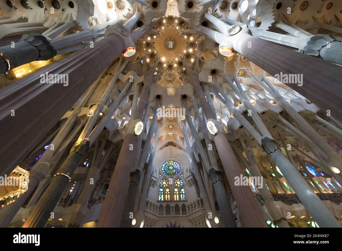 An undershot of an inside view of La Sagrada Familia with lights and ...