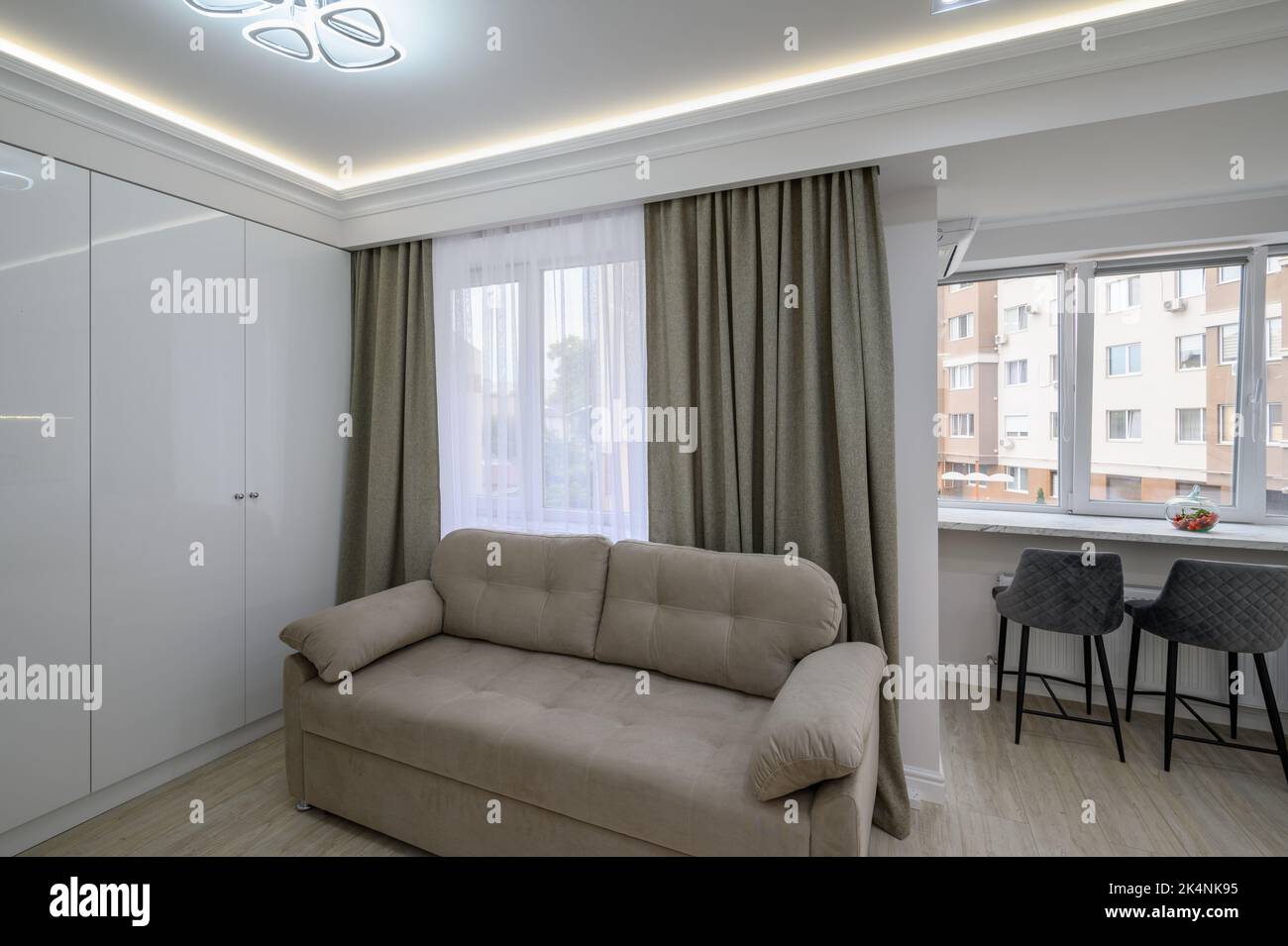 Small studio flat living room with a couch and a dining counter at ...