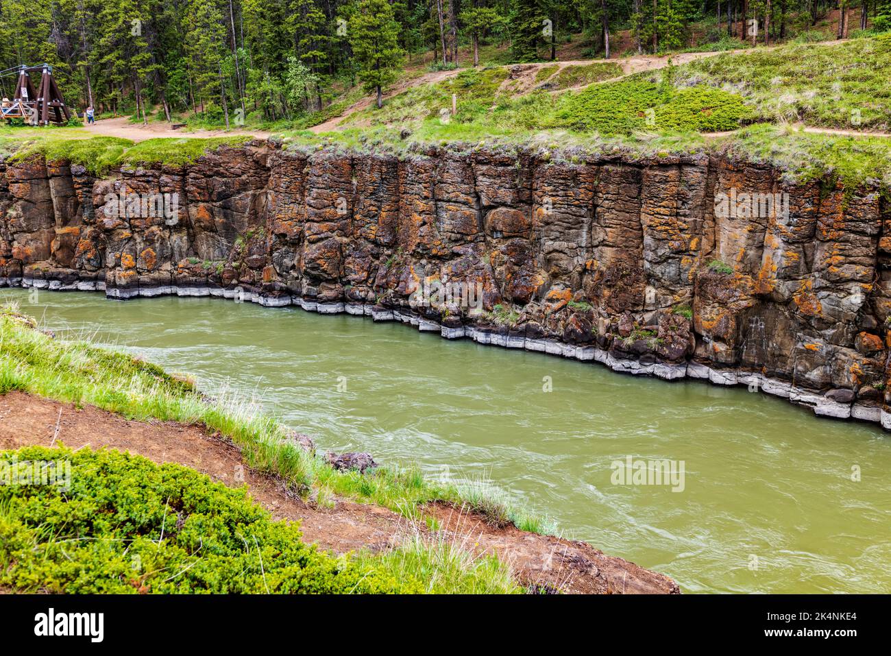 Tourists explore basalt rock formations; Miles Canyon; Whitehorse ...
