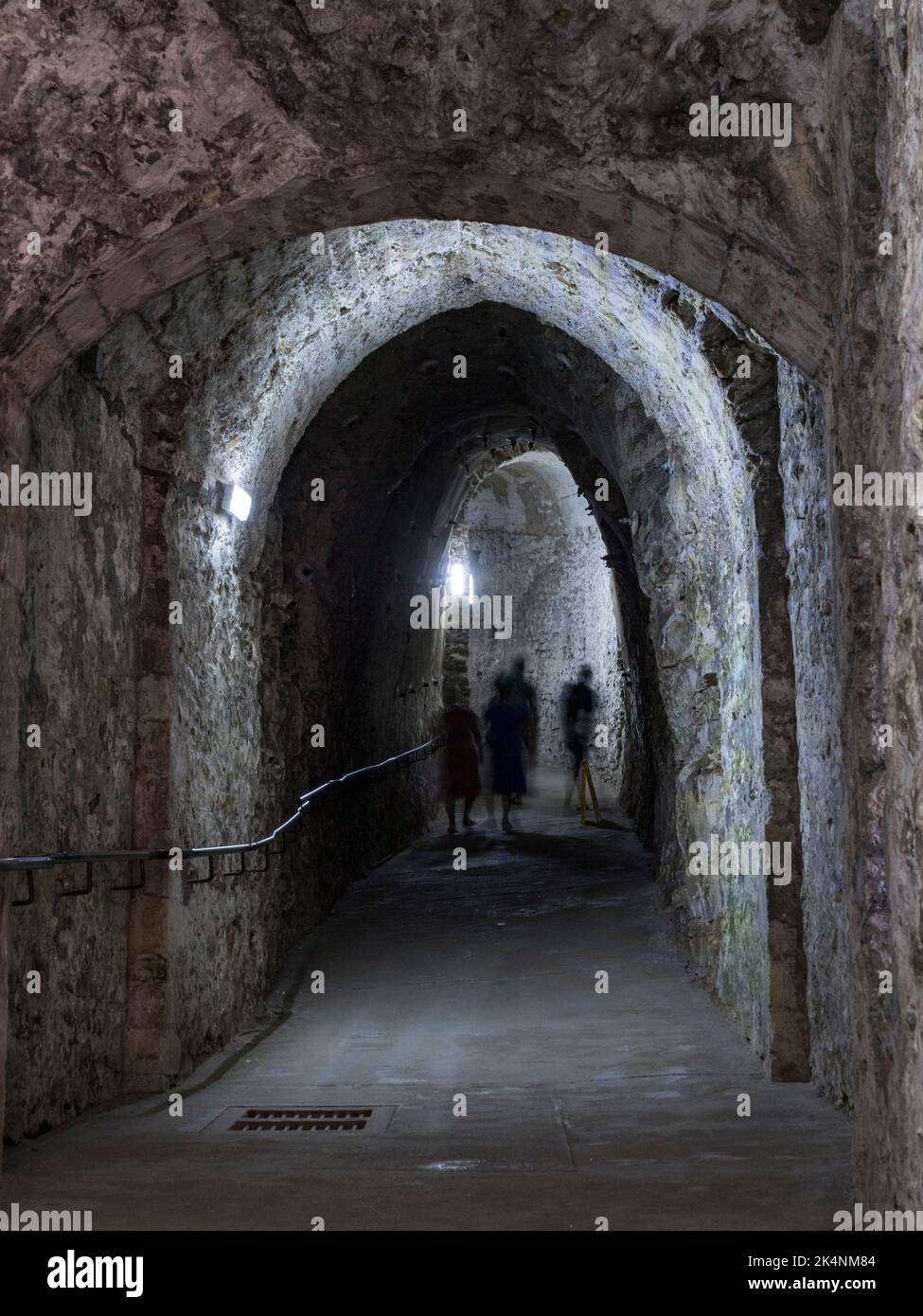 Visitors inside the medieval tunnels under Dover Castle, Kent, UK Stock ...