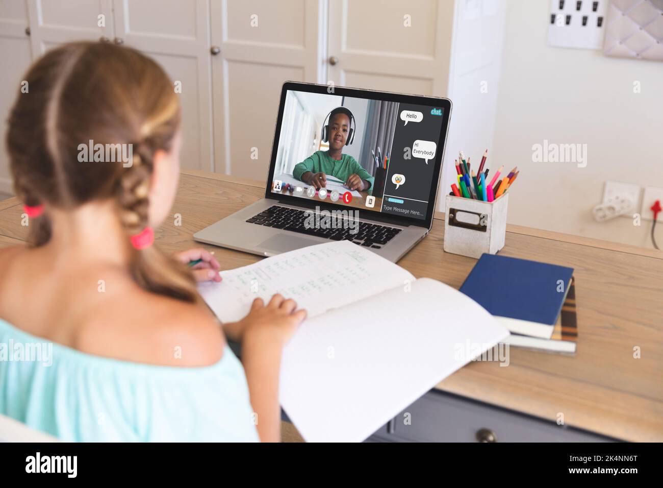 Caucasian girl using laptop for video call, with smiling elementary ...