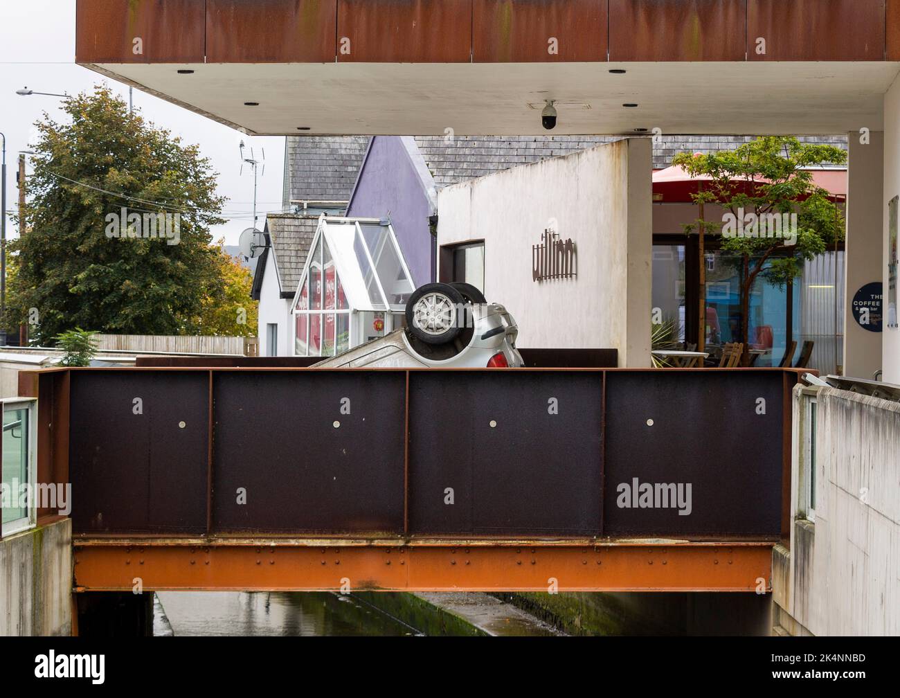 Car upside down on its roof on metal bridge Stock Photo - Alamy