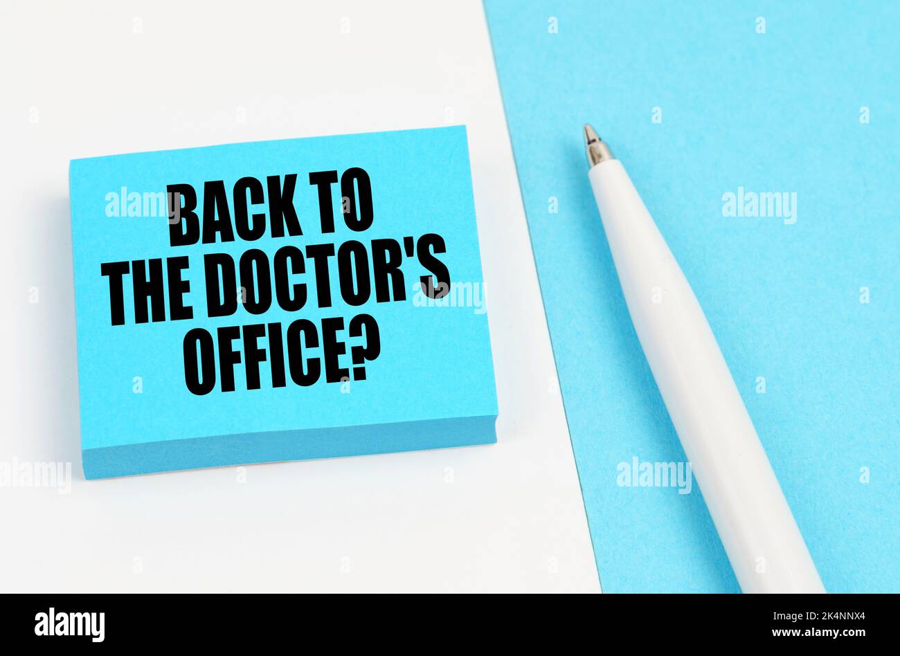 Medical concept. On a white and blue surface, a pen and blue stickers ...