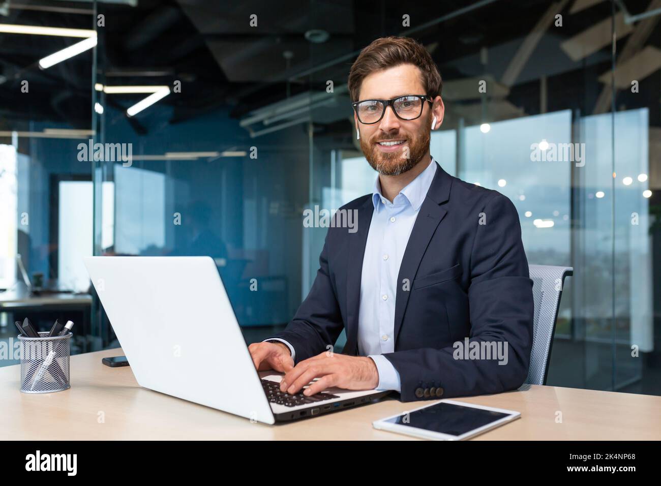 Portrait of mature boss inside office with laptop, successful and ...
