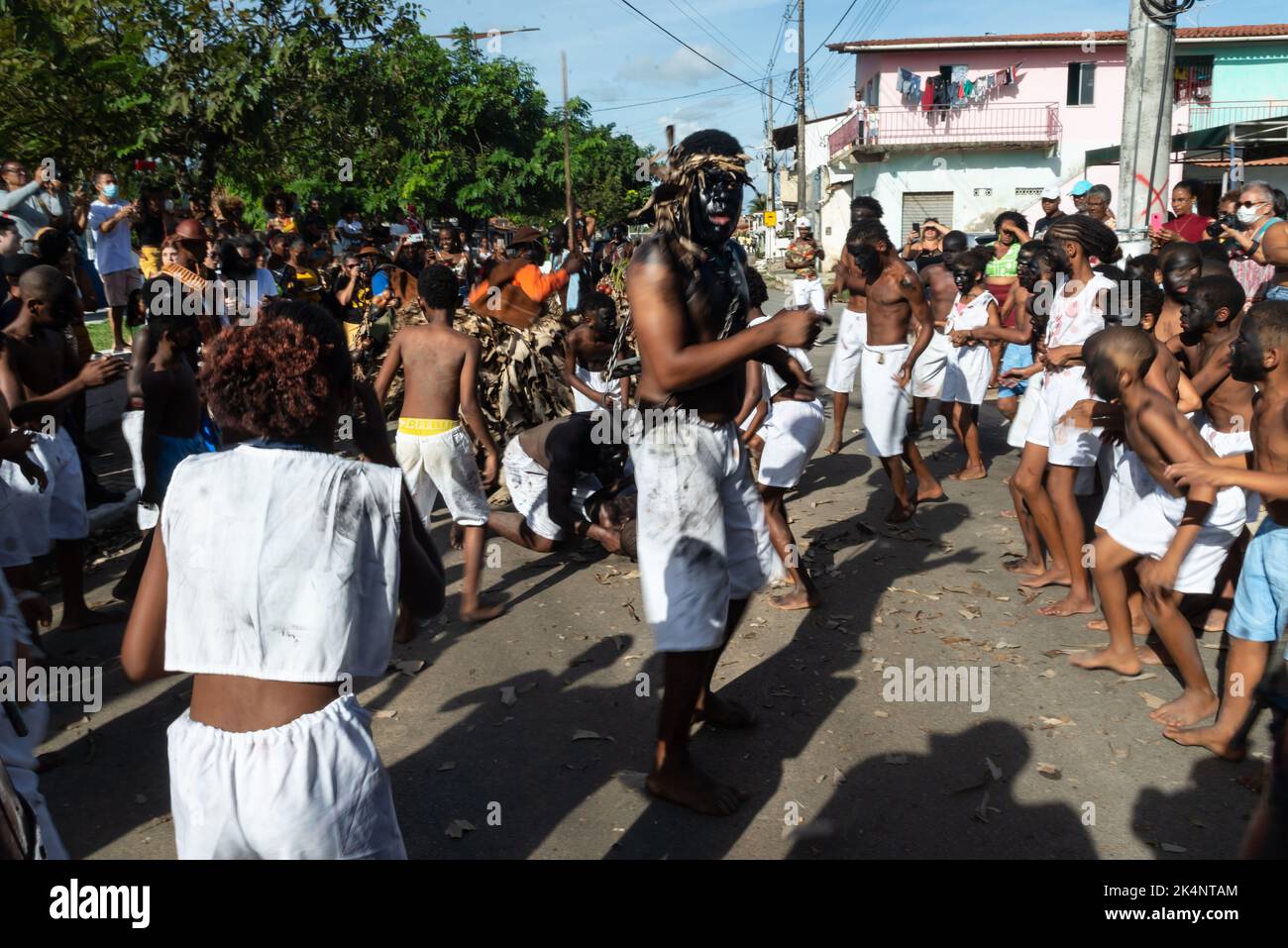 Members of the cultural event Nego Fugido sing and sit on the ground ...