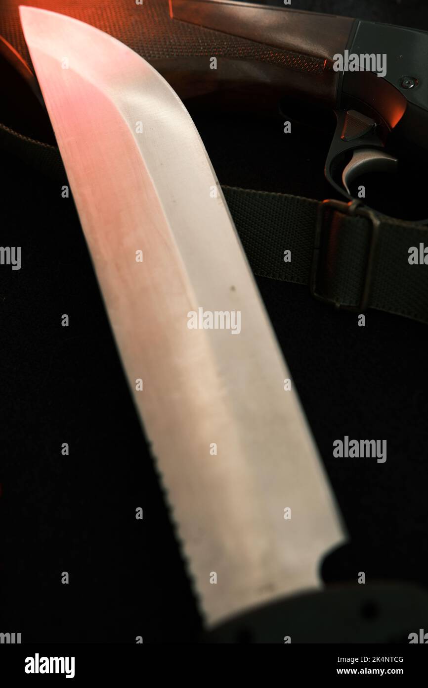 Weapon on black cloth: knife, rifle,top view. Top view of knife, rifle ...