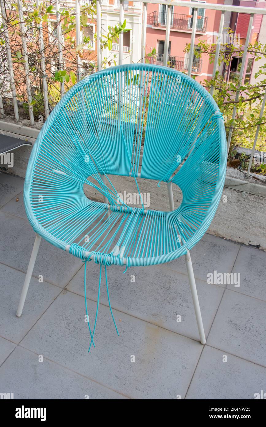 Broken terrace chair to be renewed. Blue color Stock Photo - Alamy