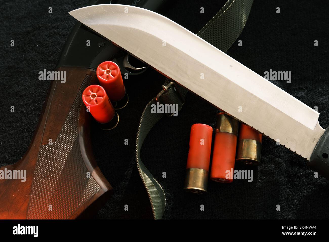 Weapon on black cloth: knife, rifle, shells,top view. Top view of knife ...