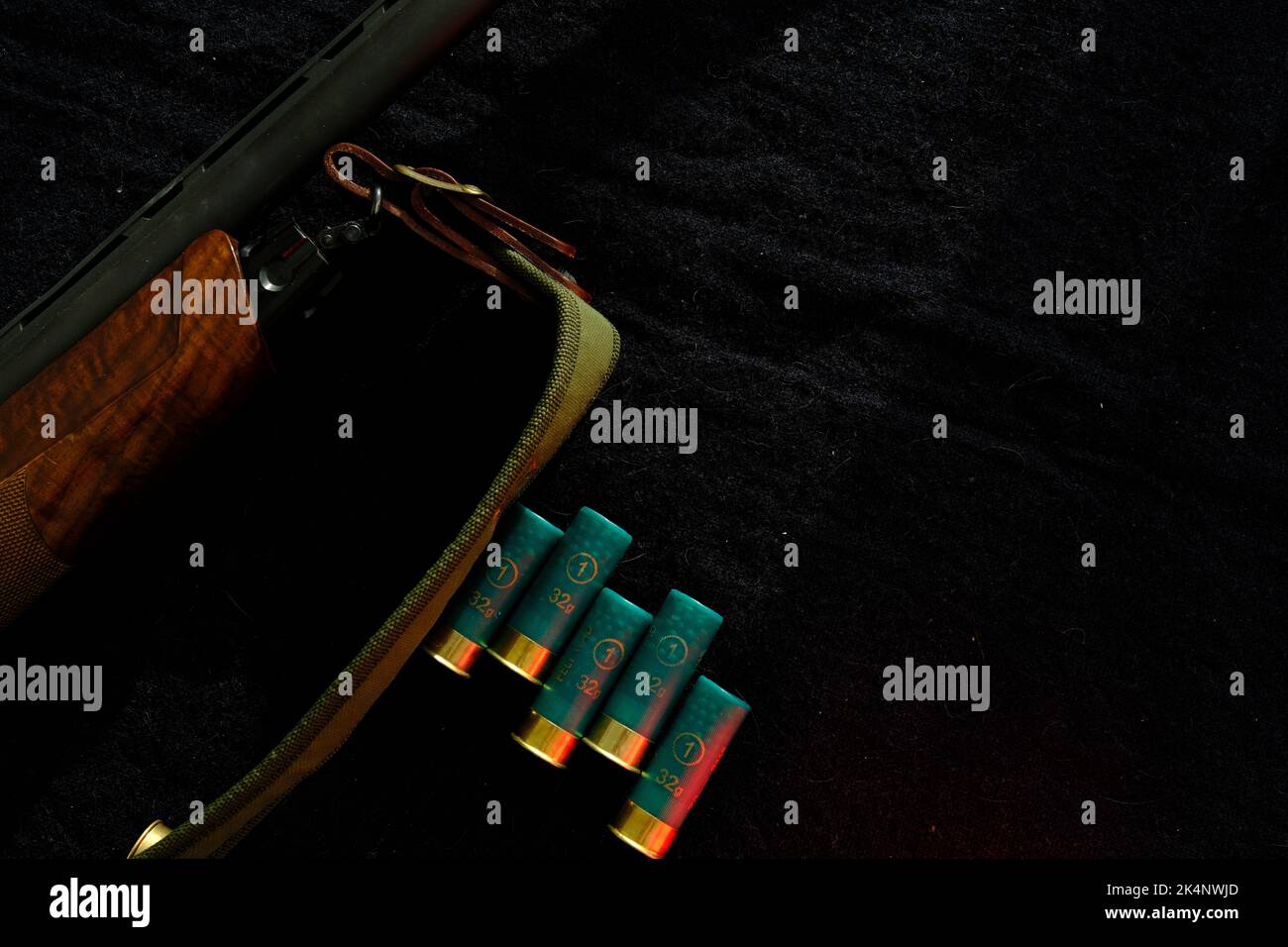 Weapon on black cloth: rifle, shells,top view. Top view of rifle ...