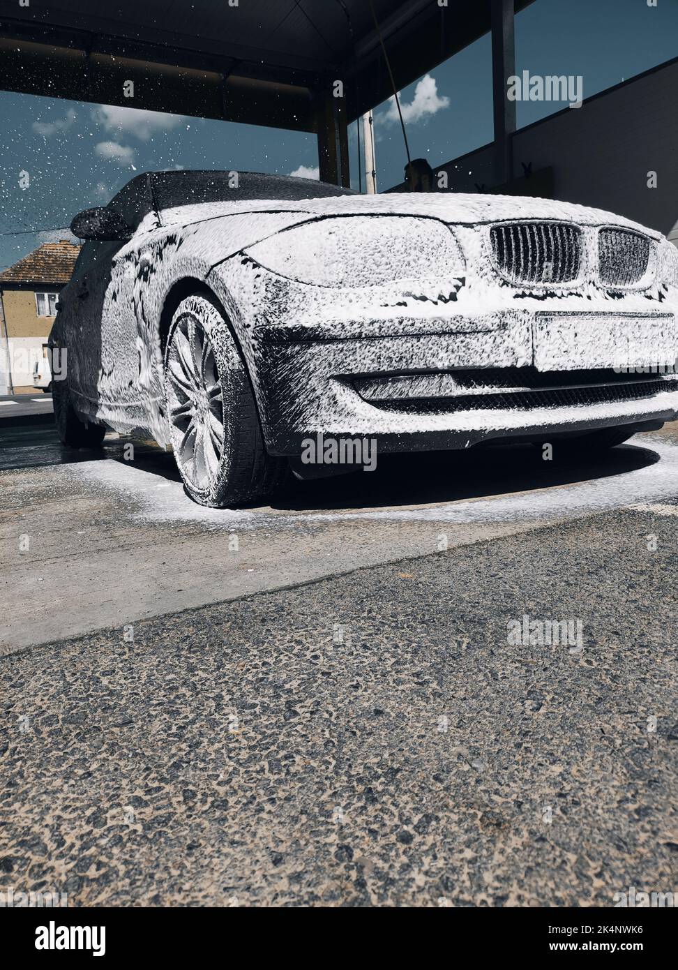 A vertical shot of the BMW car washing process Stock Photo - Alamy