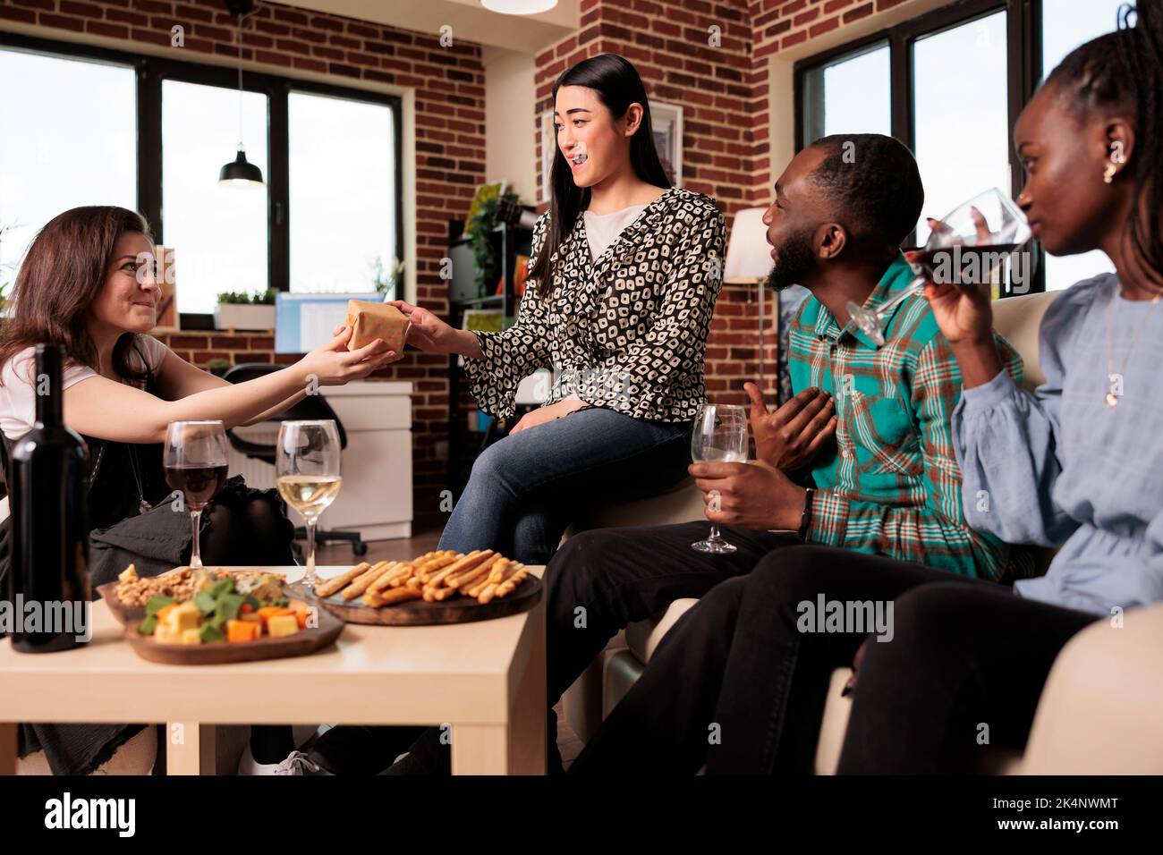 Different nationality friends happily celebrating birthday party at ...