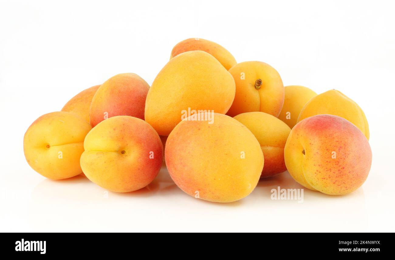 Pile of whole apricots isolated on white background.Ripe sweet fruit ...