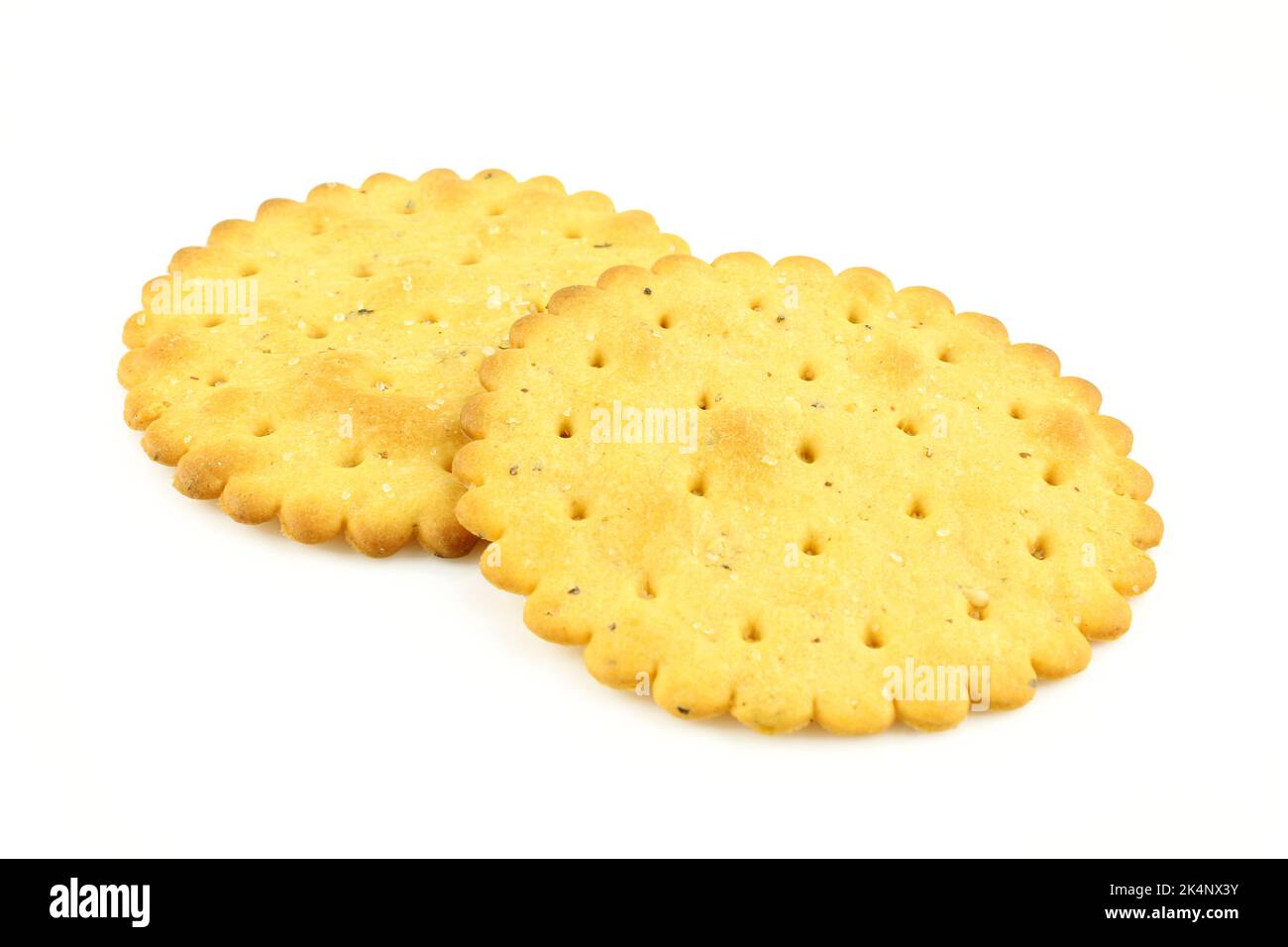 Two round salty crackers isolated on white background Stock Photo - Alamy