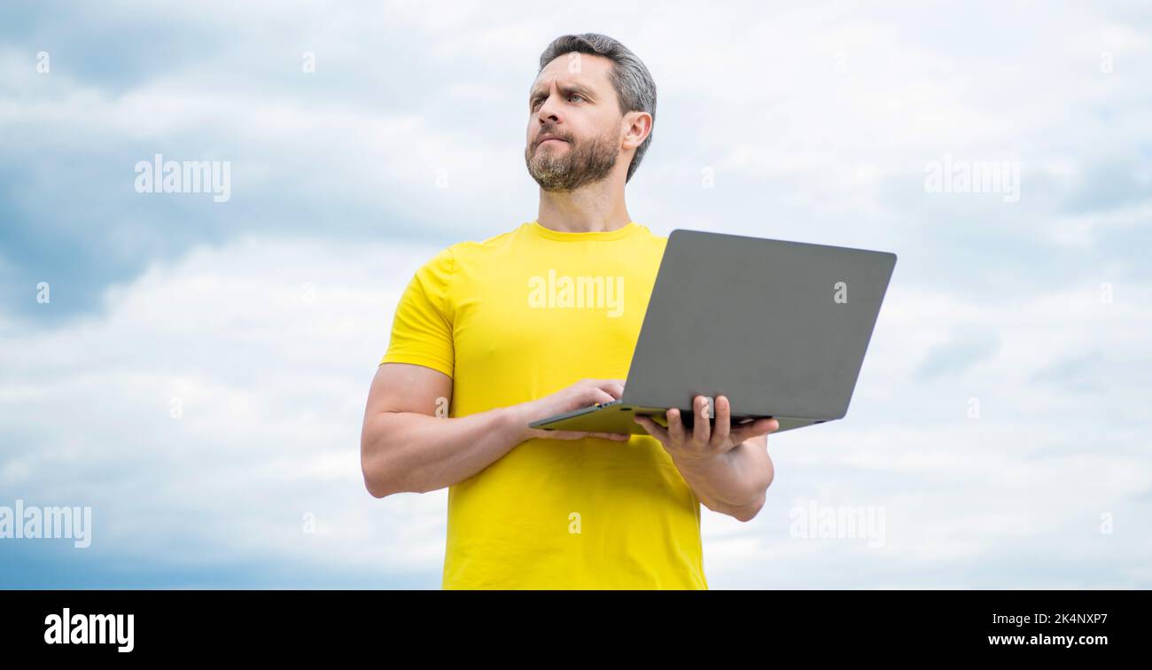 freelancer working online on laptop on sky background Stock Photo - Alamy