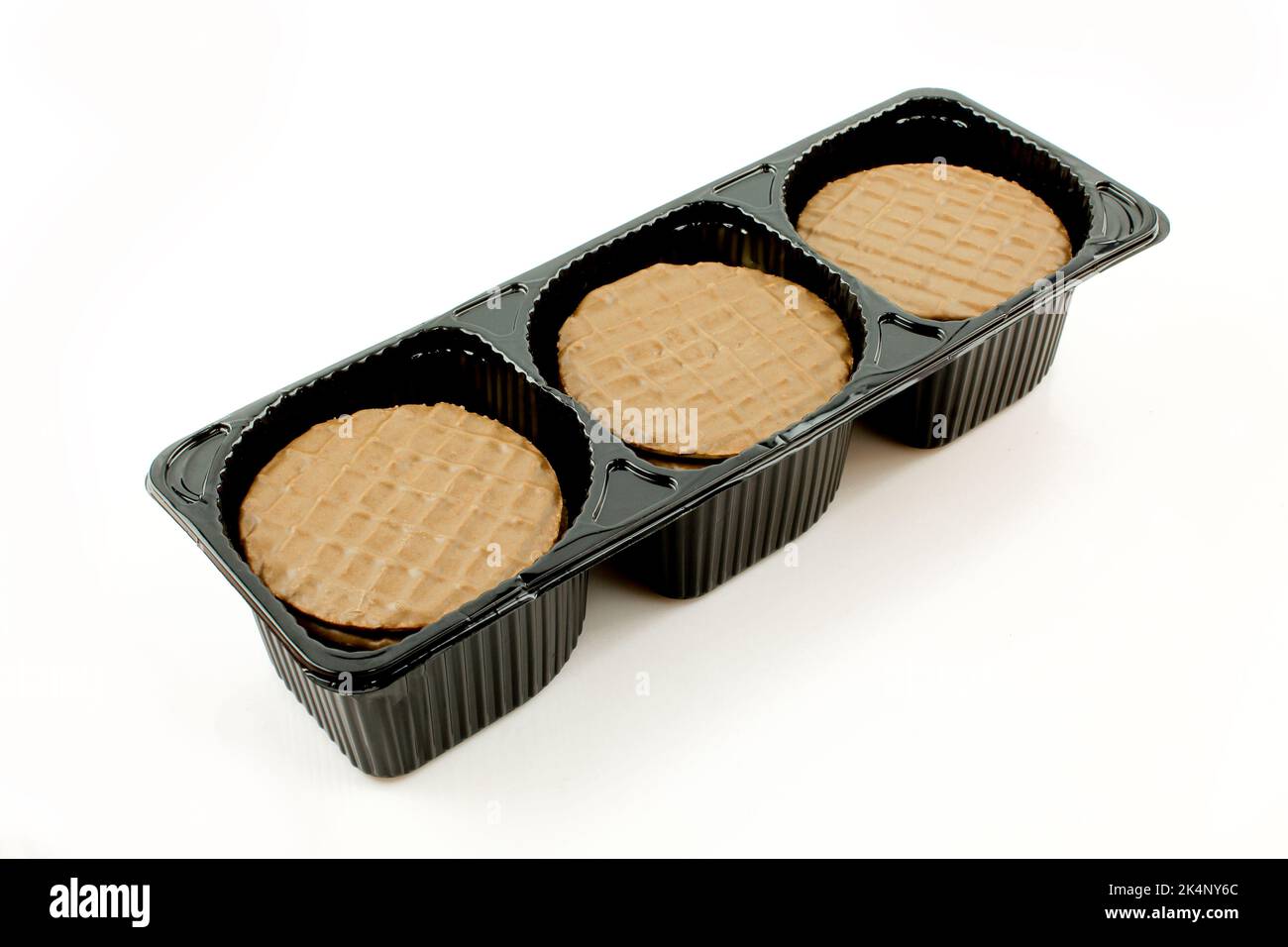 Three chocolate biscuit stacks in black plastic pack isolated on white ...