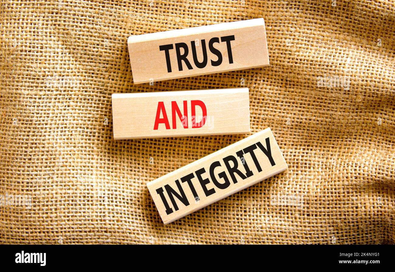 Trust and integrity symbol. Concept words Trust and integrity on wooden ...