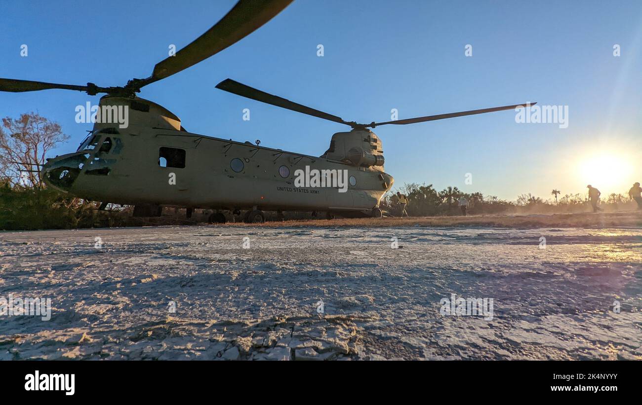 A civilian search and rescue personnel board a CH-47F Chinook ...
