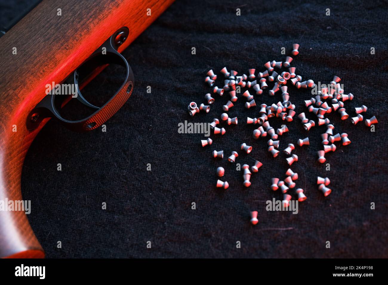 Rifle gun trigger with air pellets for hunting on cloth dark background ...