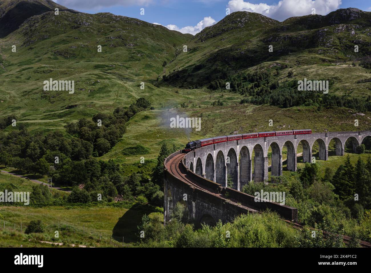 The Jacobite train passes over the Glenfinnan Viaduct in Scotland Stock ...