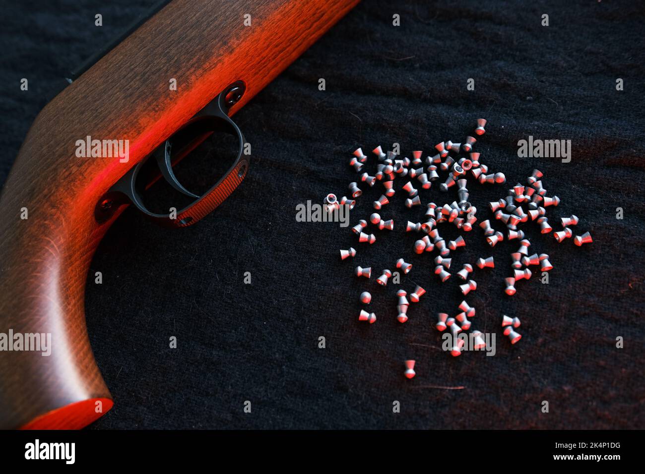 Rifle gun trigger with air pellets for hunting on cloth dark background ...