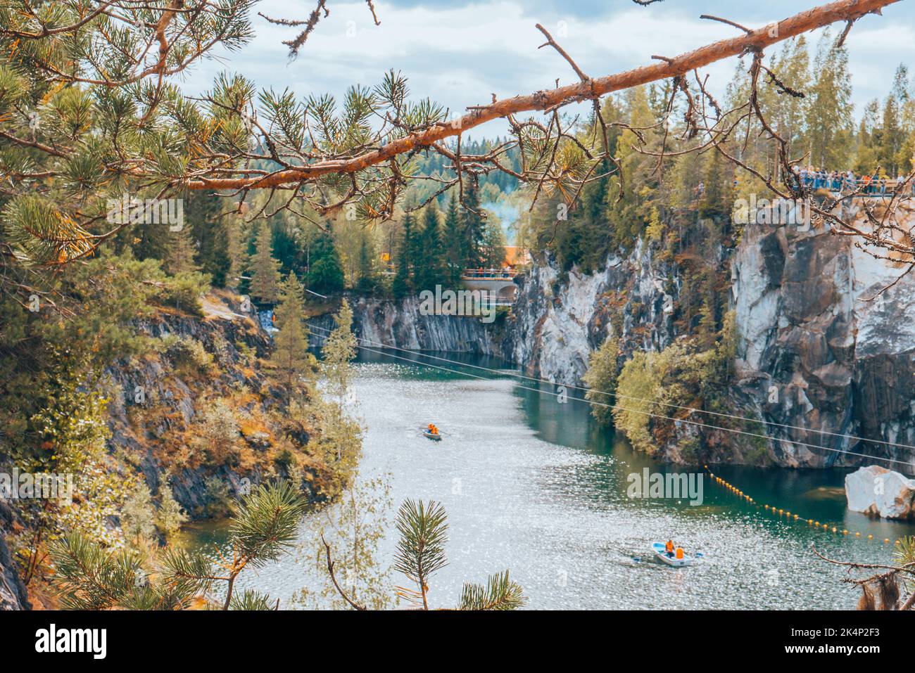 A group of people swim by boat in a picturesque place Stock Photo - Alamy