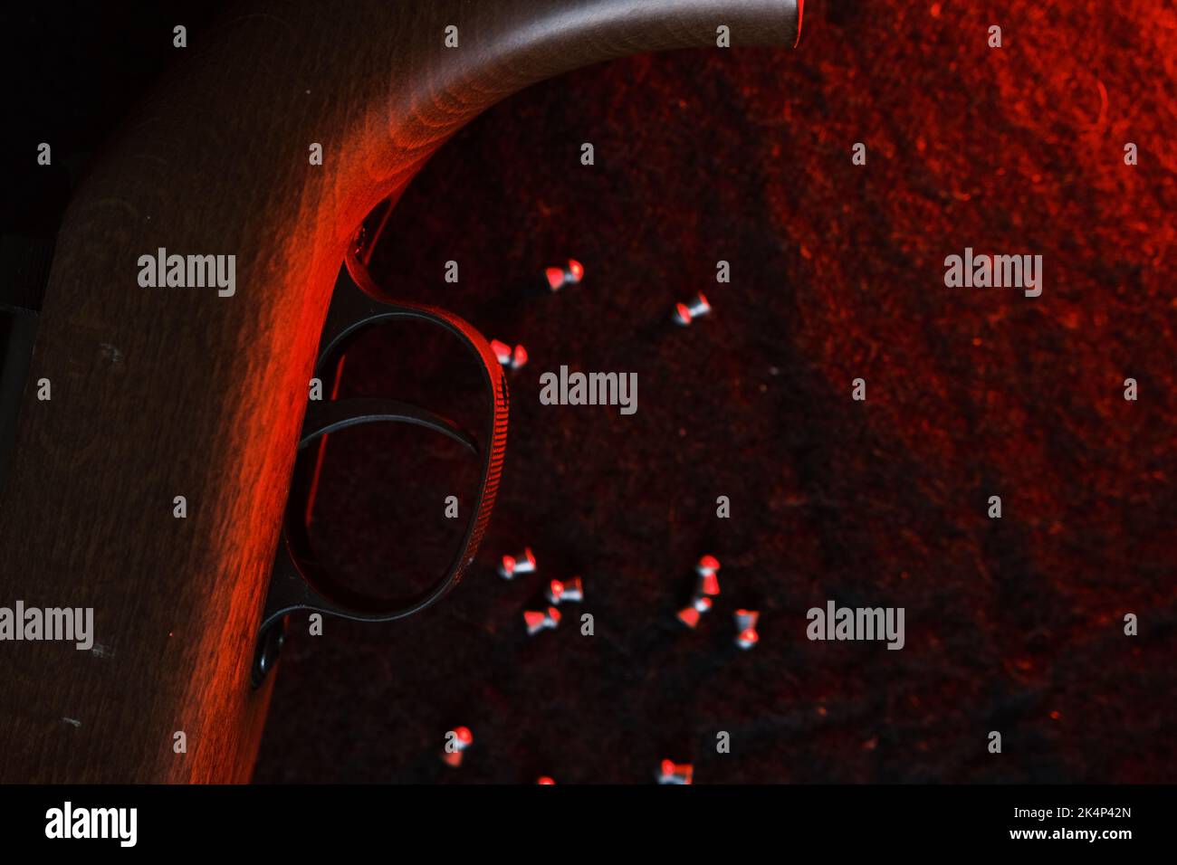 Rifle gun trigger with air pellets for hunting on cloth dark background ...