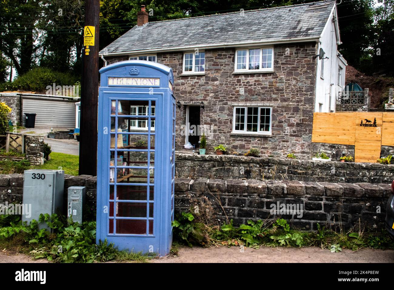 This 'recycled' BT telephone box now a library. (Welsh: Trecastell ...