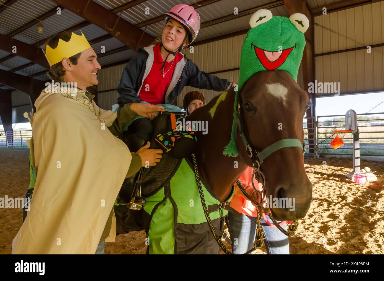 A girl rides a therapy horse at a Halloween costume party for riders in ...