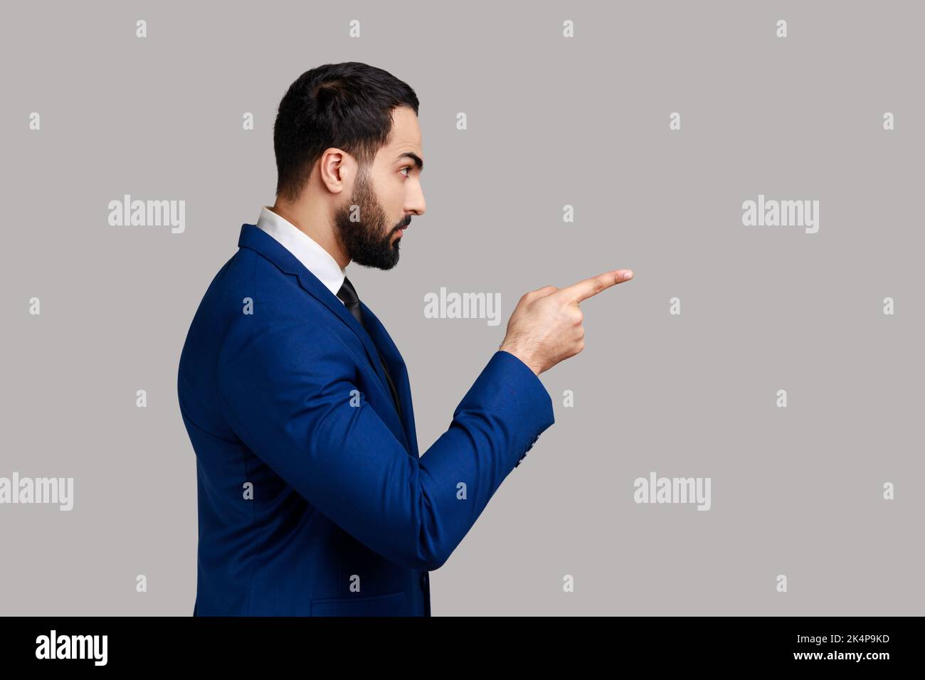 Side view portrait of serious strict bearded man standing with ...