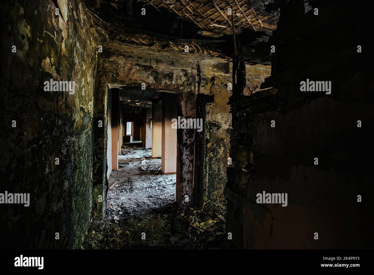 Burnt building interior. Ruined coridor walls in black soot ...