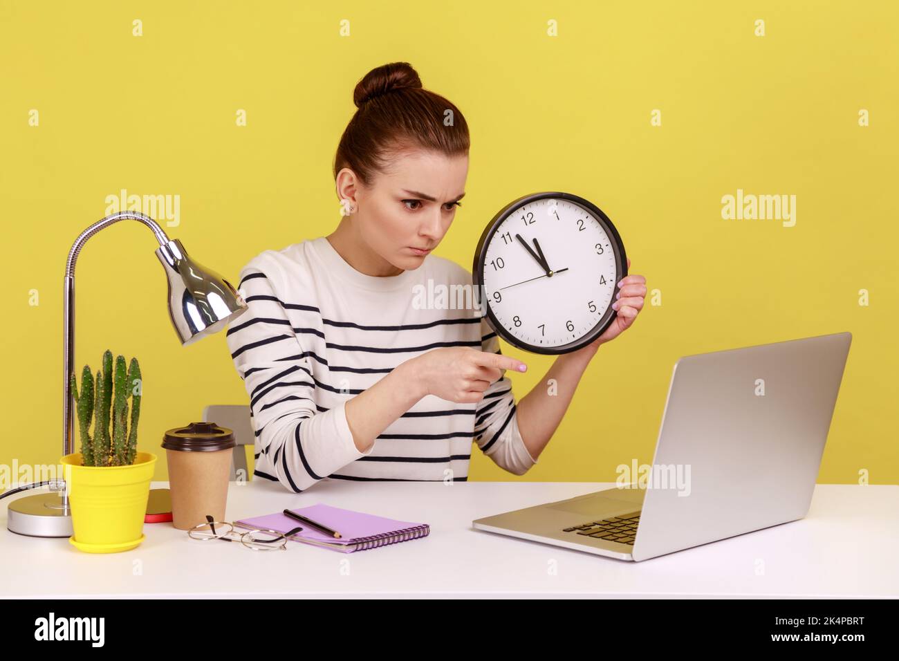 Bossy strict woman office worker holding big wall clock, time ...