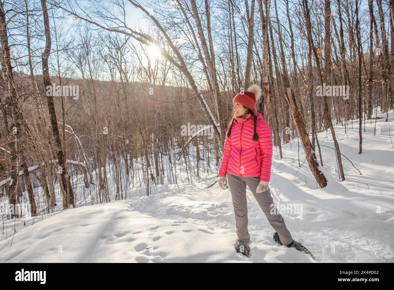 Winter snowshoe hike. Snowshoeing asian multiracial woman in winter ...