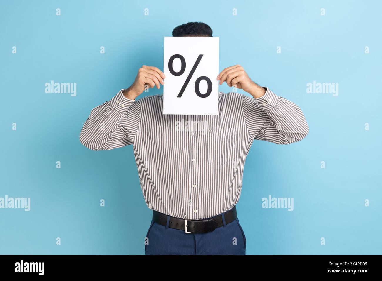 Portrait of unknown anonymous businessman hiding his face behind paper ...