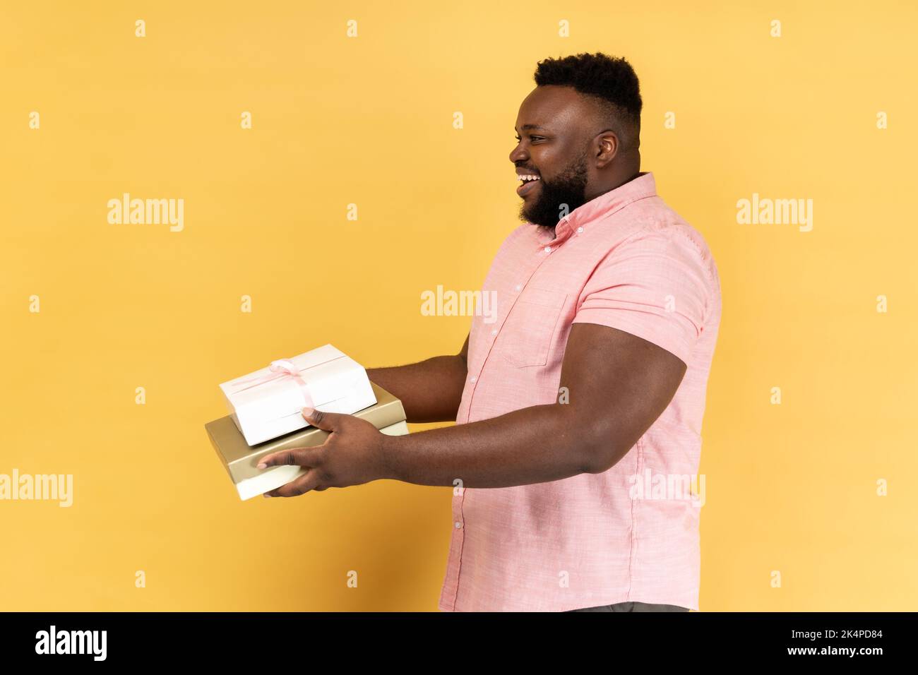 Side view portrait of satisfied happy man wearing pink shirt holding ...