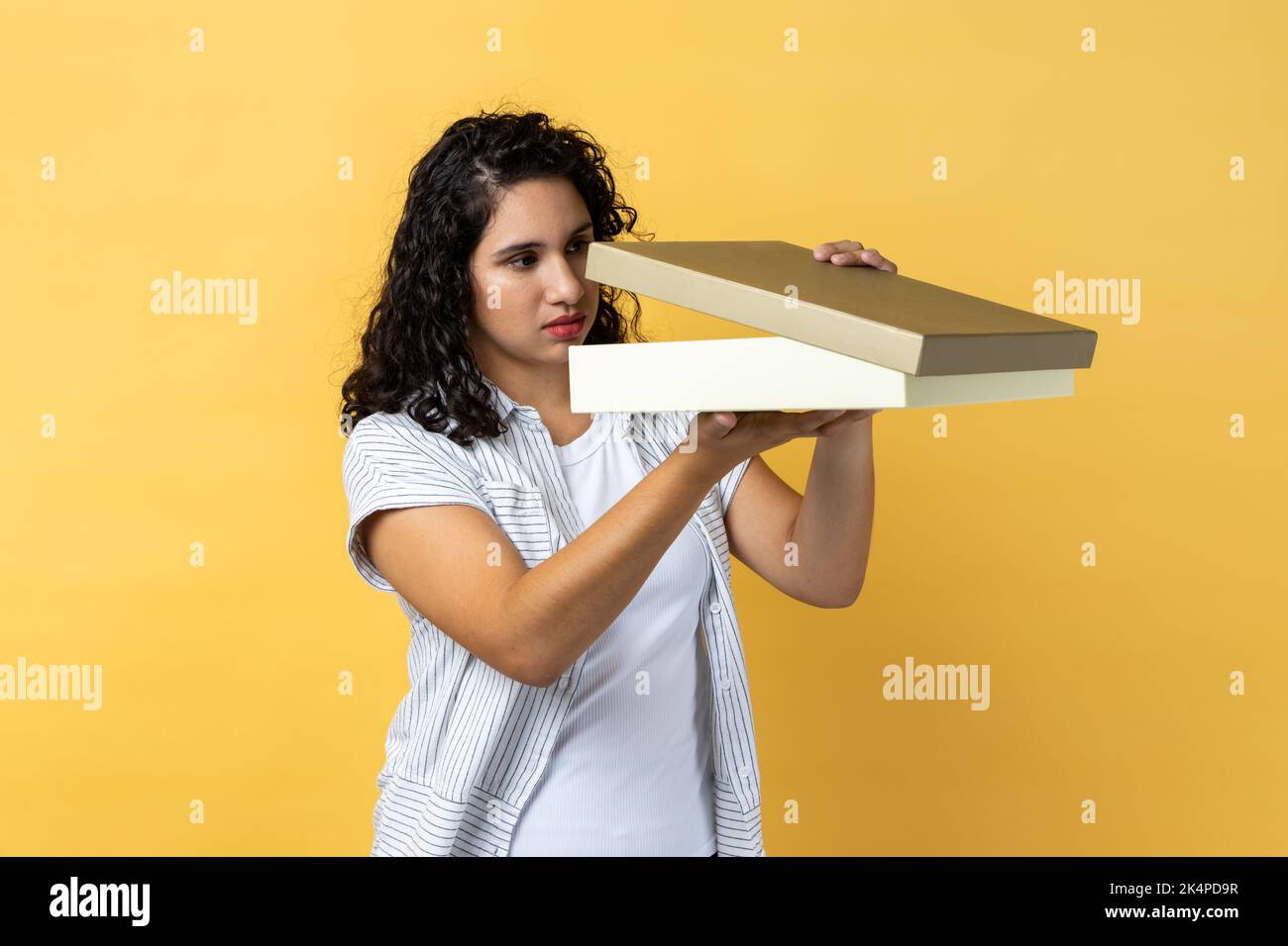 Portrait of sad disappointed woman with dark wavy hair standing with ...