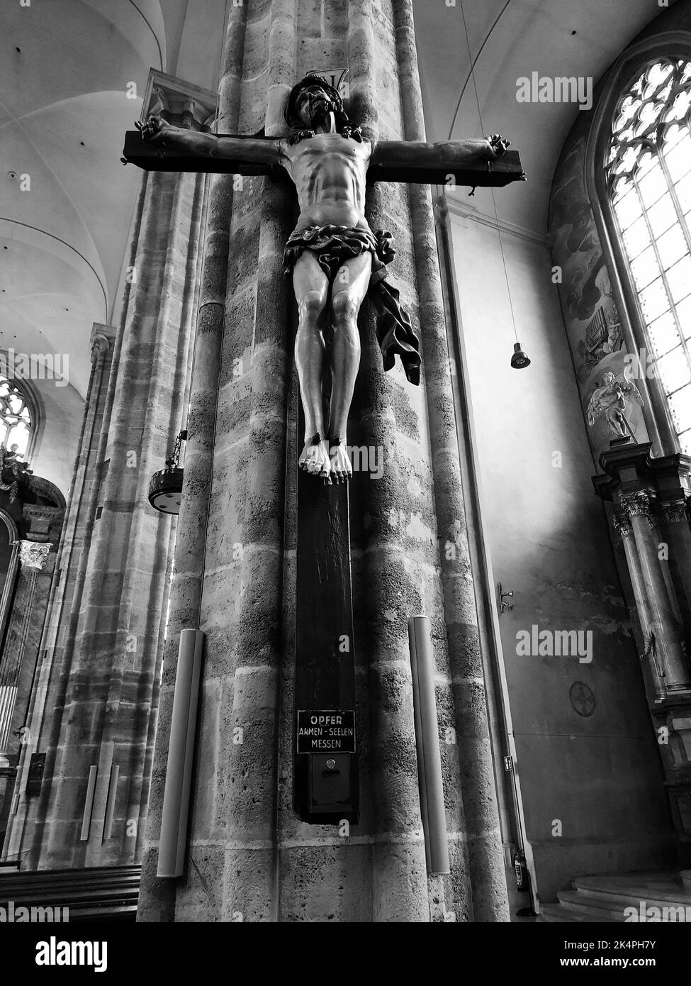 A grayscale shot of a sculpture of Jesus Christ on the cross in a church Stock Photo - Alamy