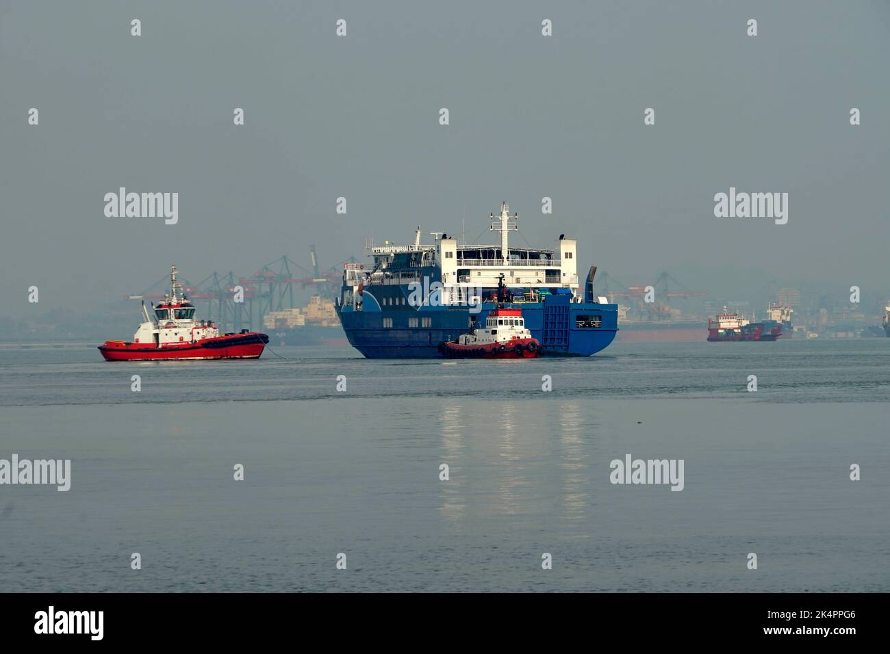 Tugboat and transportation ship maneuver in Tanjung Perak port ...