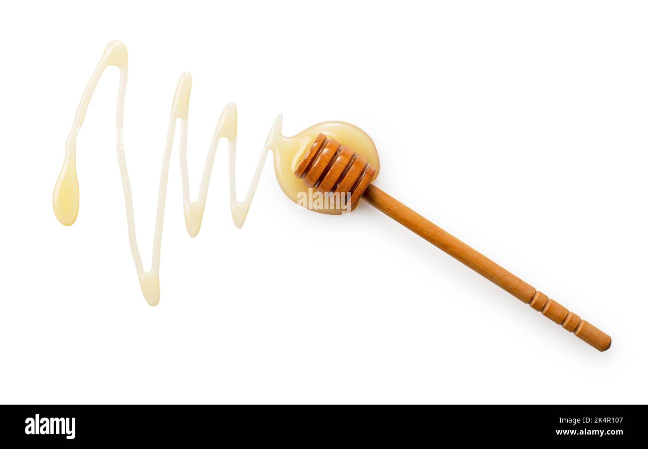Wooden honey dipper with honey on white background. View from above ...