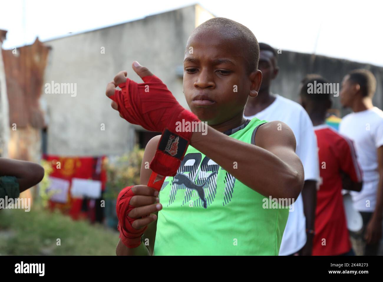 Dar Es Salaam, Tanzania. 2nd Oct, 2022. A boy puts on boxing gloves in ...