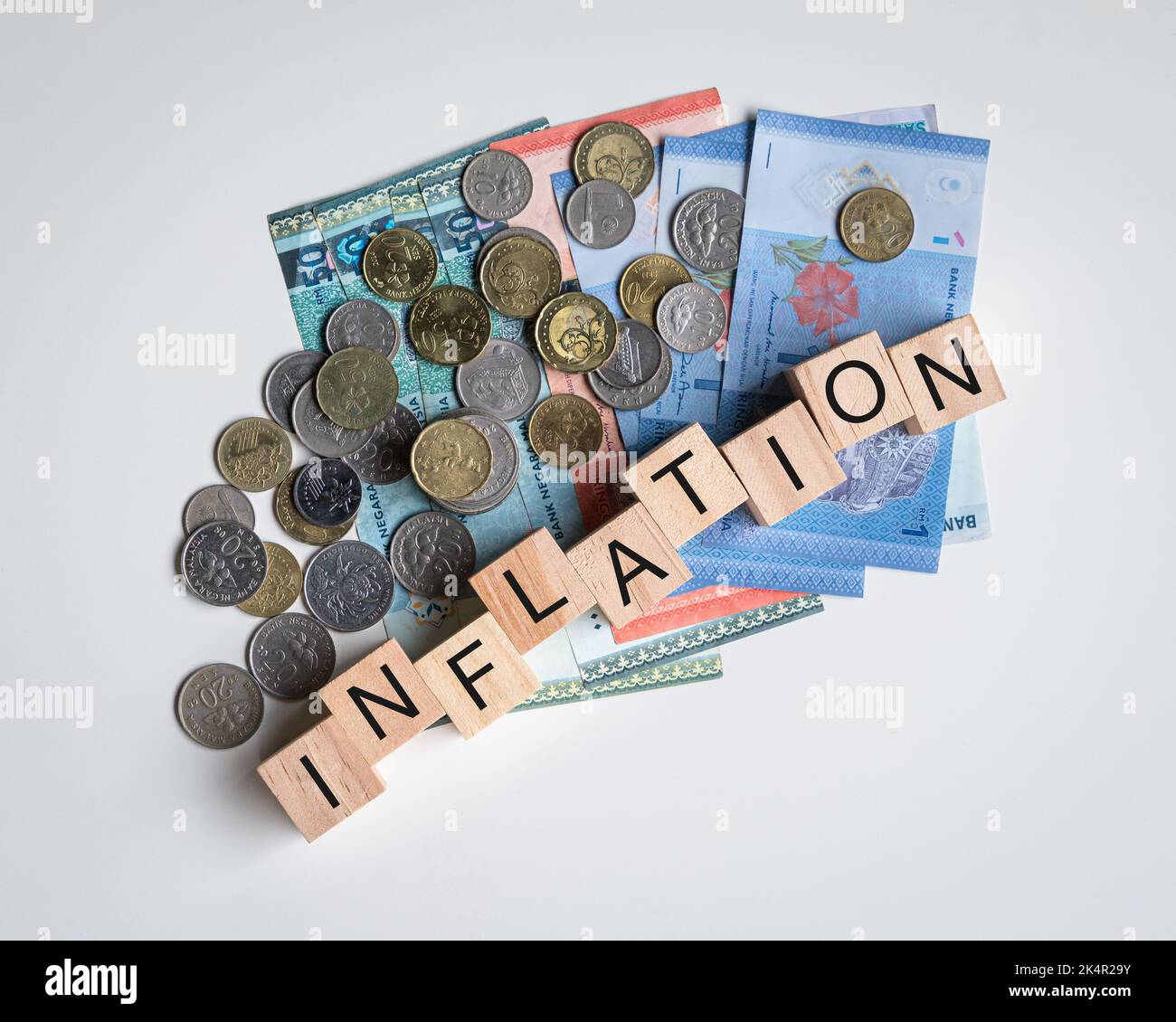 Letters of the alphabet Inflation on wood cubes with currency notes and ...