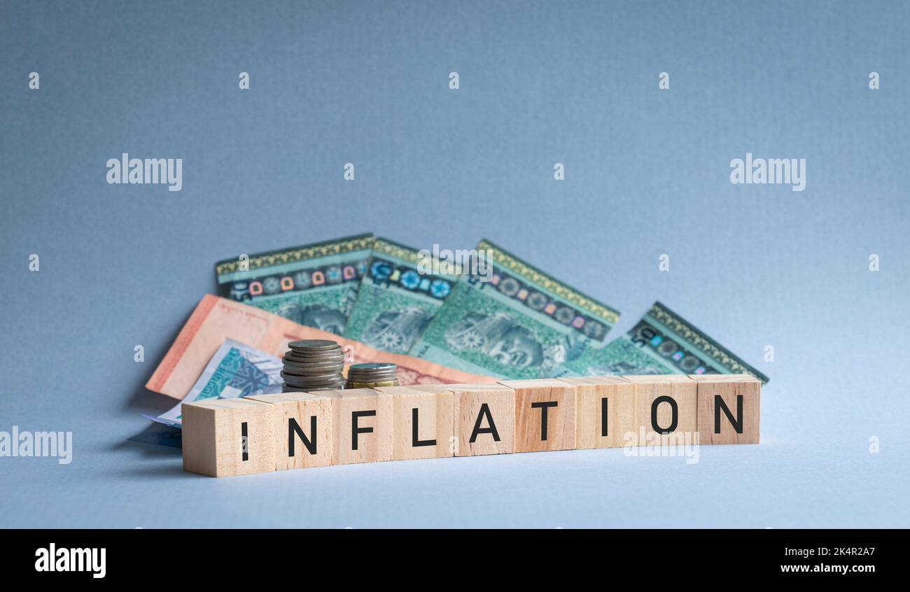 Letters of the alphabet Inflation on wood cubes with currency notes and ...