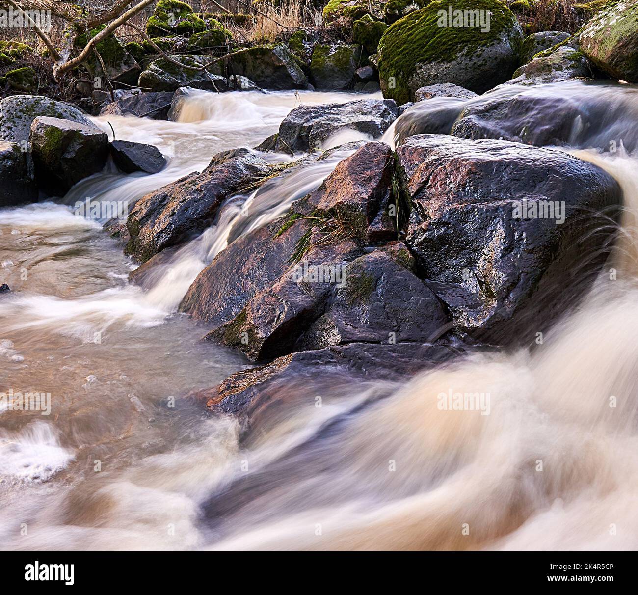 A beautiful foamy river flowing down on rocks Stock Photo - Alamy