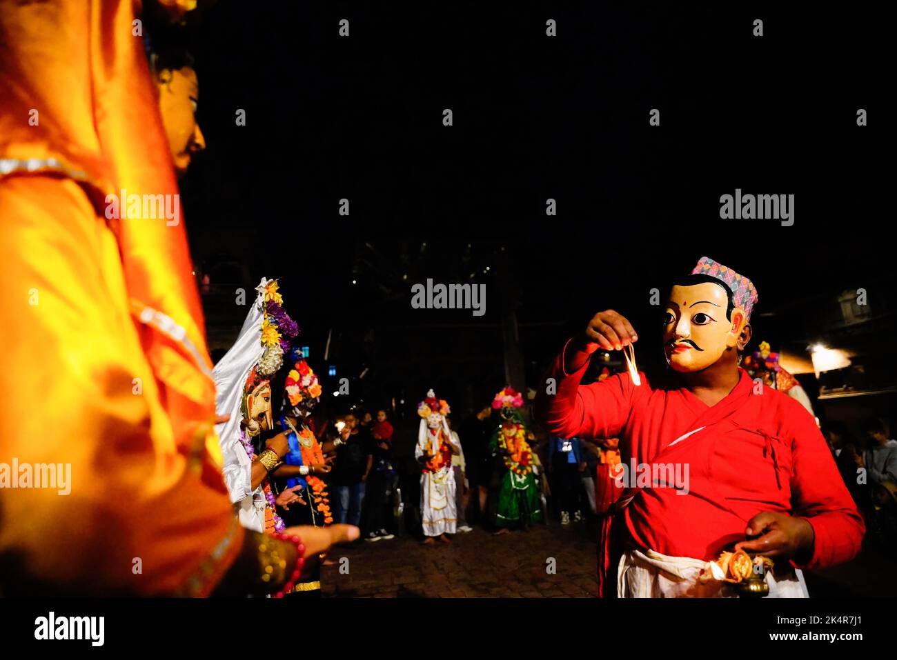 A priest performs a ritual to a masked deity before the Astamatrika ...