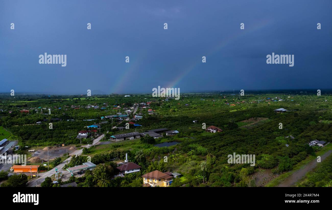 Rainbow in the sky after heavy rain in the countryside. Top view of a ...