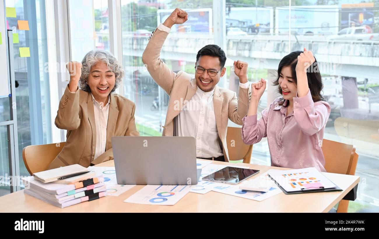 Cheerful and successful Asian businesspeople celebrating their success ...