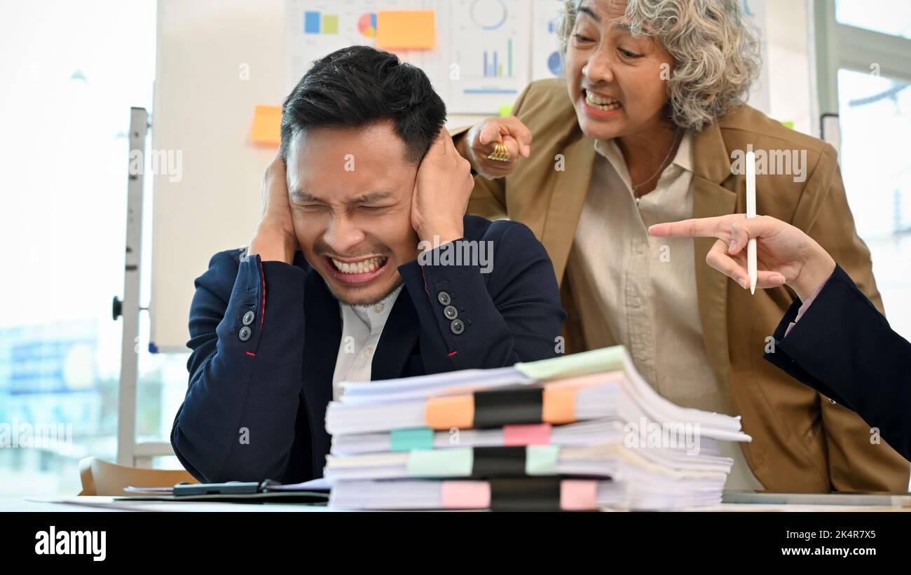 Stressed and frustrated millennial Asian businessman or male employee ...