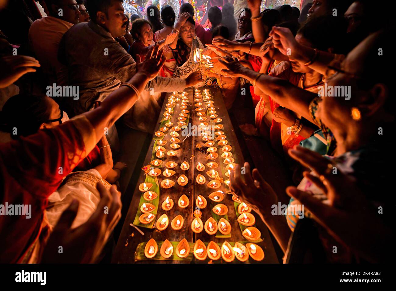 Kolkata, India. 03rd Oct, 2022. Hindu devotees light Diyas (clay lamps ...