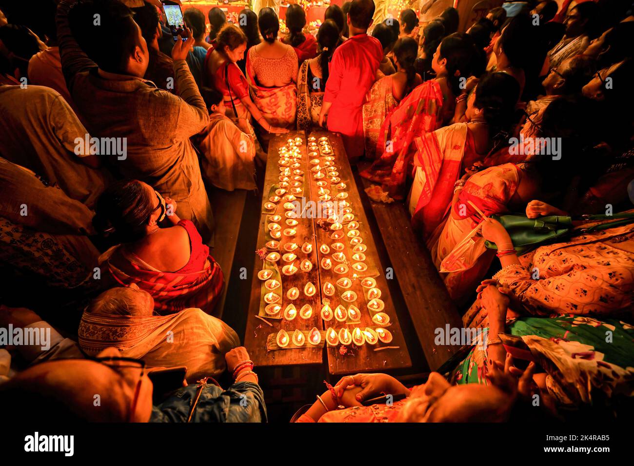 Kolkata, India. 03rd Oct, 2022. Hindu devotees light Diyas (clay lamps ...