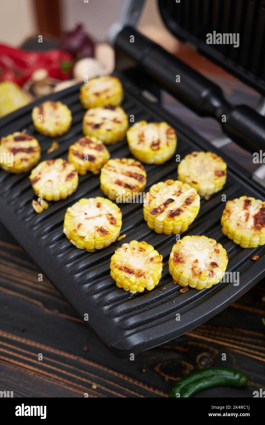 cooking at home on electric grill - sliced corn cobs Stock Photo - Alamy
